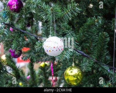 Fragment of a white decorated Christmas tree with two blue balls Stock ...