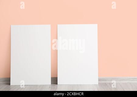 Blank posters near color wall Stock Photo - Alamy