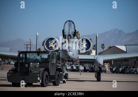 An MB-4 Coleman aircraft tug tractor pulls an A-10C Thunderbolt II ...