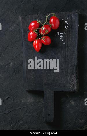 Ripe tomato branch over wooden background Stock Photo - Alamy
