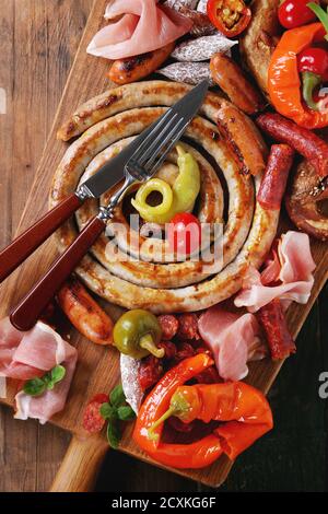 Sausage with knife over cutting board Stock Photo - Alamy