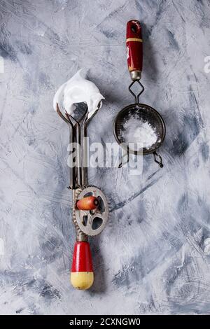 Vintage whisk on concrete background. Selective focus Stock Photo - Alamy