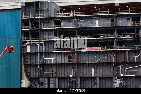 Workers at BAE Systems Govan Shipyard in Glasgow leave via the front ...