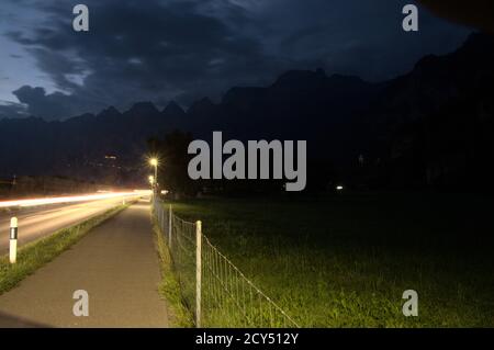 Night view of the Churfirsten in the Swiss Alps with light trails from ...