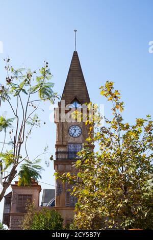 Yellow clock tower standing tall at setubal fishing port, overlooking ...