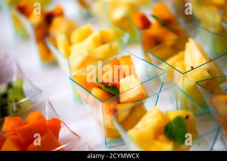 fruit buffet with single portions and cut fruit melon peach apple pear ...