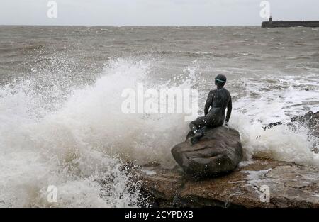 Waves hit the Folkestone Mermaid statue in Folkestone, Kent. Parts of ...