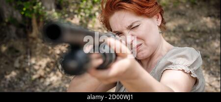 Woman shooting with pump gun. Direct macro detail close-up shotgun ...
