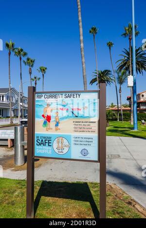 Rip current warning sign at the beach along Lake Michigan Stock Photo ...