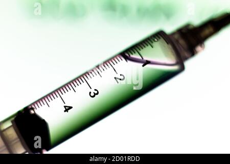In this photo illustration a medical syringe seen displayed in front of ...