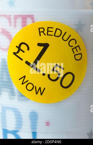 Yellow sticker with a reduced price on a joint of meat in a supermarket ...