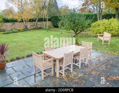 English back garden in Autumn with shed, log store and Victorian Lamp ...