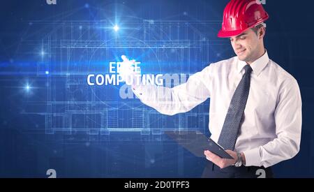 Handsome architect with helmet drawing EDGE COMPUTING inscription, new ...
