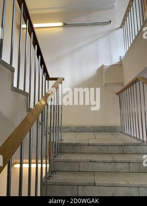 A vertical shot of a corridor inside an ancient building with arches ...