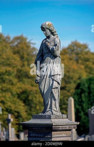 Cemetery mourning statue of a woman Stock Photo - Alamy