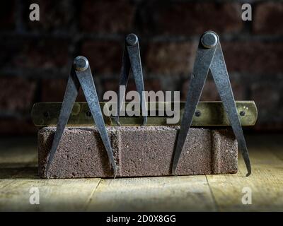 Set of three engineers odd leg callipers on timber flooring resting ...