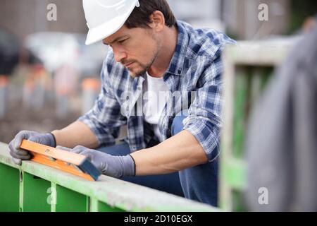 the installation wizard measures the foundation level Stock Photo - Alamy