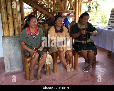 Woman of the Cofan ethnic group in their traditional dress taking care ...