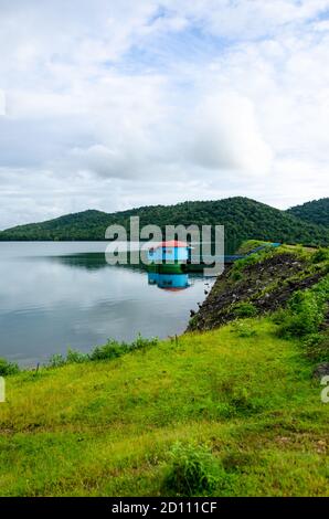 Serene view of Chapoli dam reservoir during monsoon season in Canacona ...