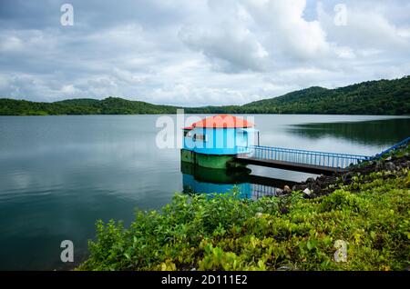 Serene view of Chapoli dam reservoir during monsoon season in Canacona ...