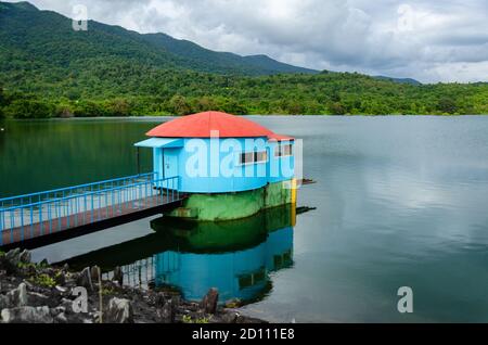 Serene view of Chapoli dam reservoir during monsoon season in Canacona ...