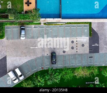 Aerial top view condominium swimming pool residential complex among low ...