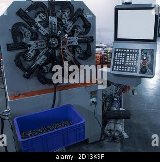 Automatic CNC spring coiling machine. Industrial machinery Stock Photo ...