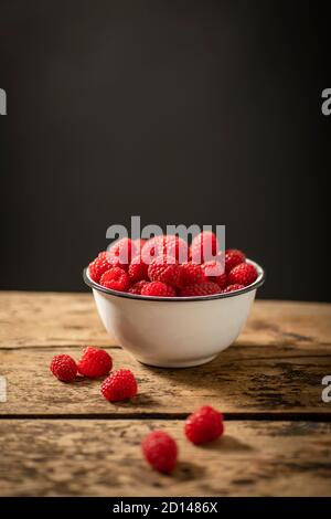 Lots of red ripe raspberries on a bush. Close up of fresh organic ...