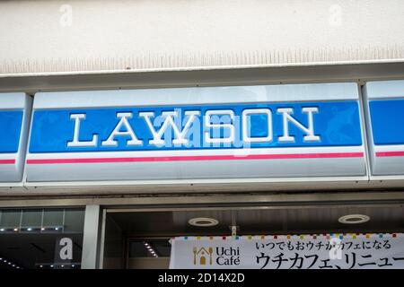 A Lawson convenience store sign in front of a store in Tokyo's ...