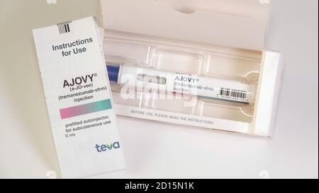Ajovy auoinjector with box and patient instruction booklet on a table ...