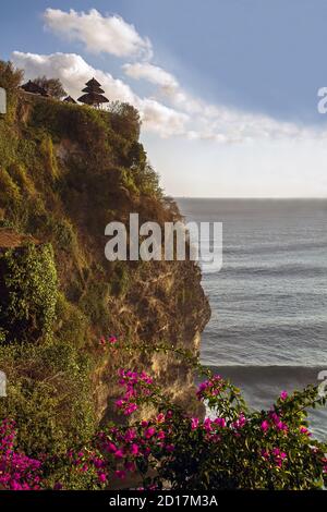 Balinese Temple on the Cliff against the warm sky Stock Photo - Alamy
