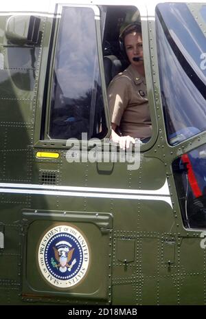 Marine One lands on the flight deck of the amphibious assault ship USS ...