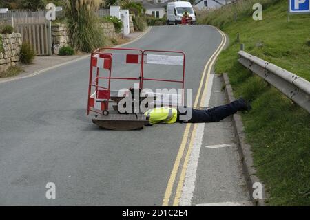 A British Telecoms engineer installing fibre optic cable at the top of ...