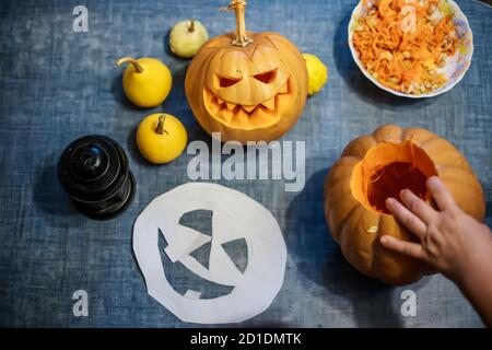 Woman carving big orange pumpkin into jack-o-lantern for Halloween ...