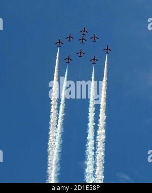 Red arrows hawks display team in arrow formation trailing white - blue ...