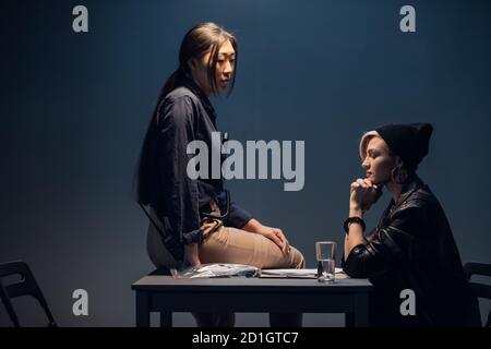 Handcuffed Asian young woman in prisoners uniform Stock Photo - Alamy