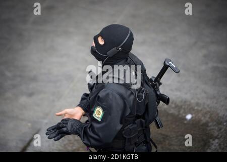 A member of Iranian police special forces, acting as a robber, performs ...