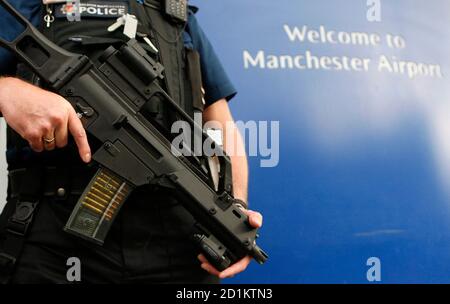 Armed police officer at main entrance gates to the Balmoral Estate ...