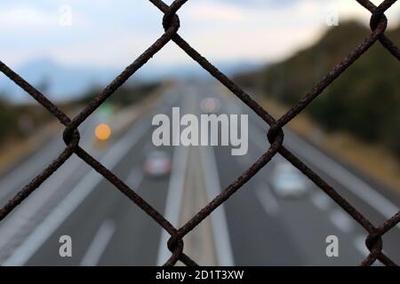 Fence overlooking Japanese highway, taken in Beppu, Oita, Japan. In ...