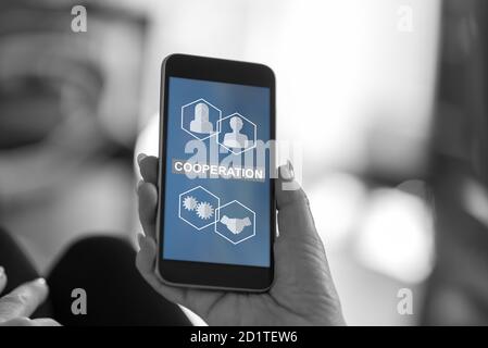 Smartphone screen displaying a cooperation concept Stock Photo - Alamy