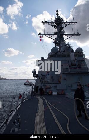 The guided-missile destroyer USS Ross docks at Naval Station Norfolk ...