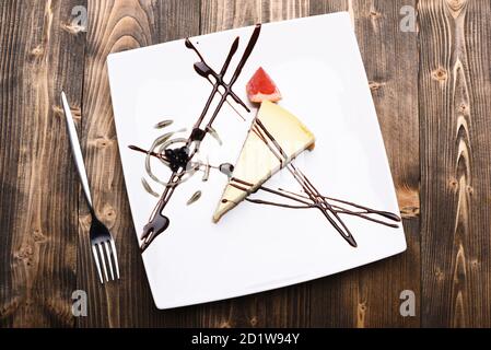 Dessert with chocolate lines, blueberry and grapefruit triangle on ...