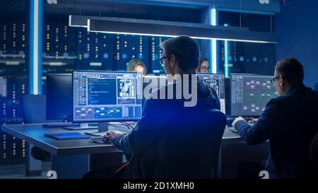 Team of Young IT Programers Working on Desktop Computers in Data Center ...