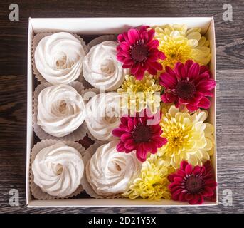 Homemade zephyr or marshmallows in a box on a pink background, Top view ...