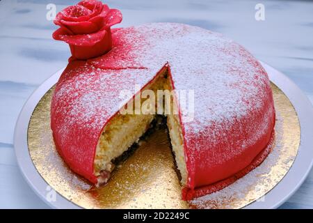 Red cake covered with marzipan or mastic with a cut piece, copy space ...