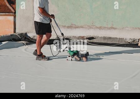 Worker welding pvc roof membrane by heater with welder machine Stock ...