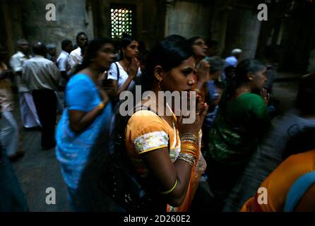 Hindu worshippers make offerings to their gods & goddesses at a Ganga ...