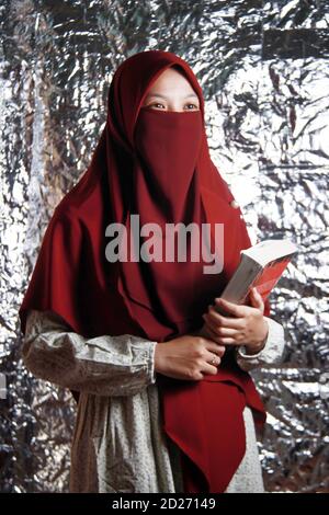 A woman holding a red book, closeup shot Stock Photo - Alamy