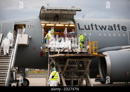 Wounded soldier lying in a hospital bed, with his leg in traction. He ...