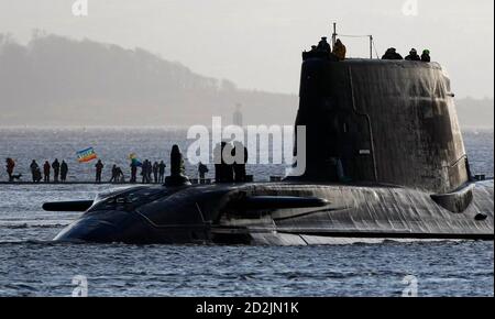Crew members gather near the sail of the nuclear-powered attack ...